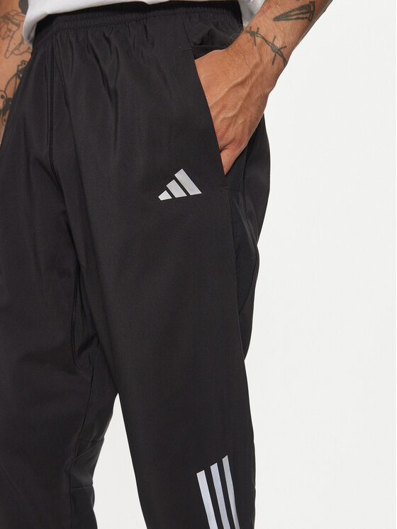 adidas Spodnie dresowe Own the Run HR6611 Czarny Regular Fit | Modivo.pl